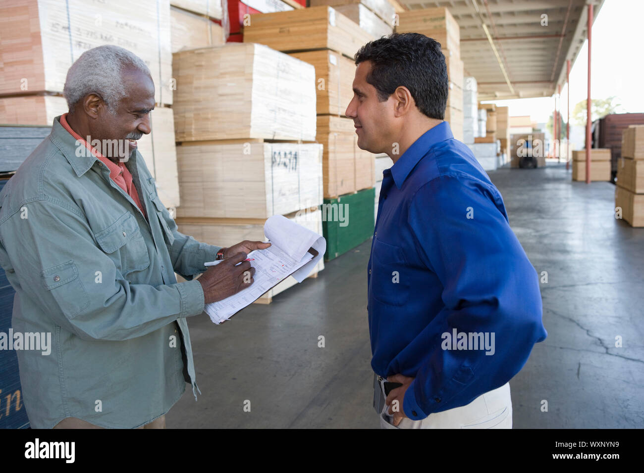 Men stock-taking in warehouse Stock Photo - Alamy