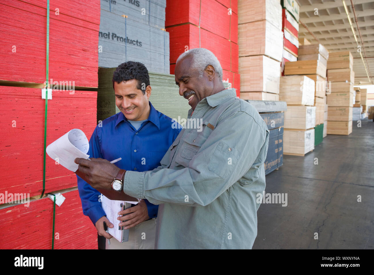 Men stock-taking in warehouse Stock Photo - Alamy
