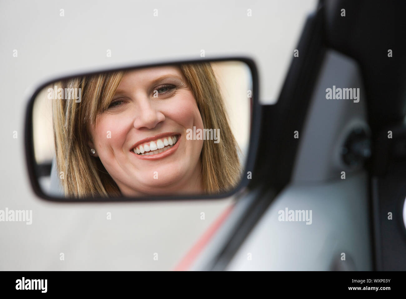 Woman in Side-View Mirror of Car Stock Photo - Alamy