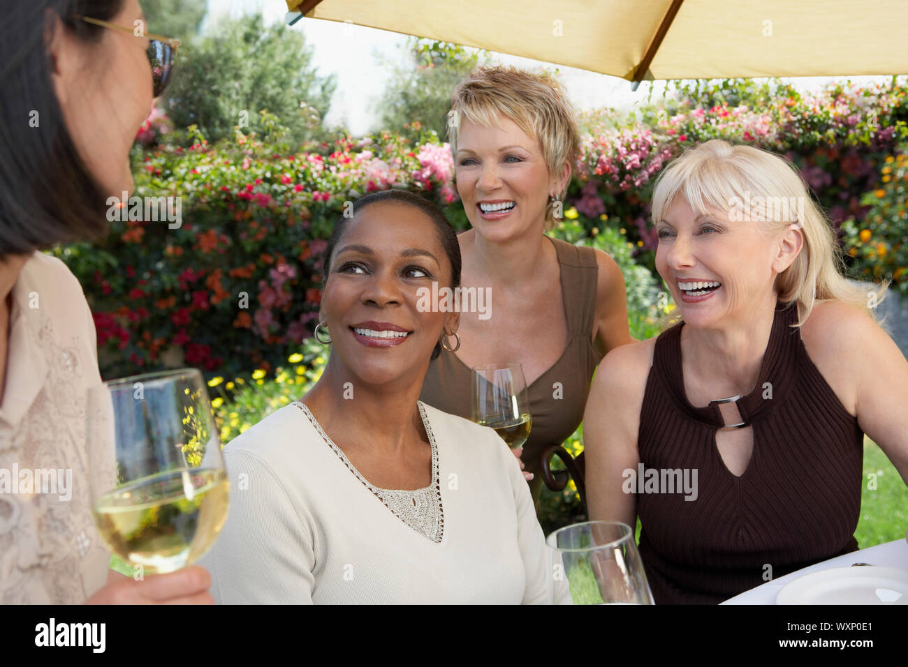 Middle aged friends socializing outdoors hi-res stock photography and ...