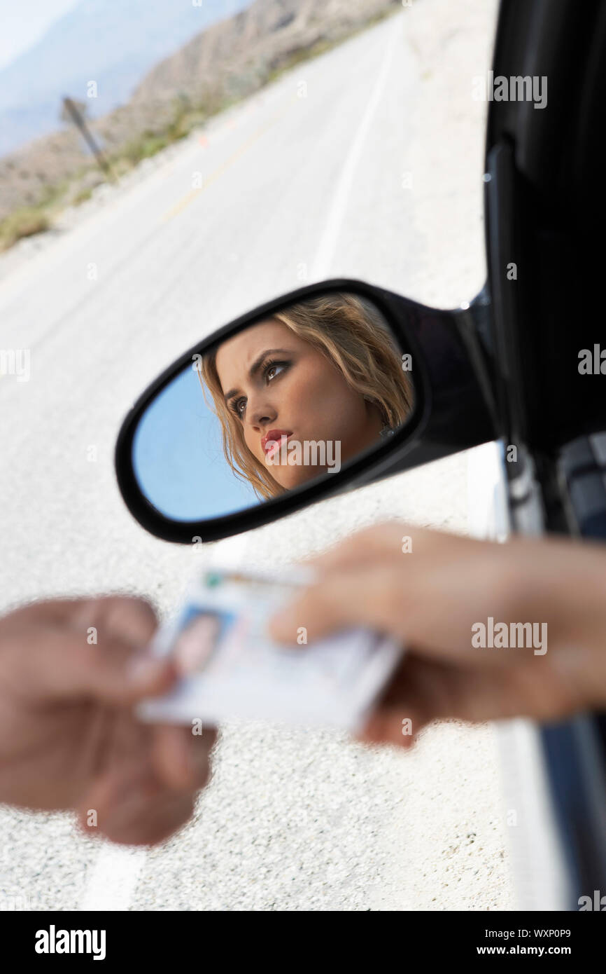 Woman Handing a Police Officer her License Stock Photo - Alamy