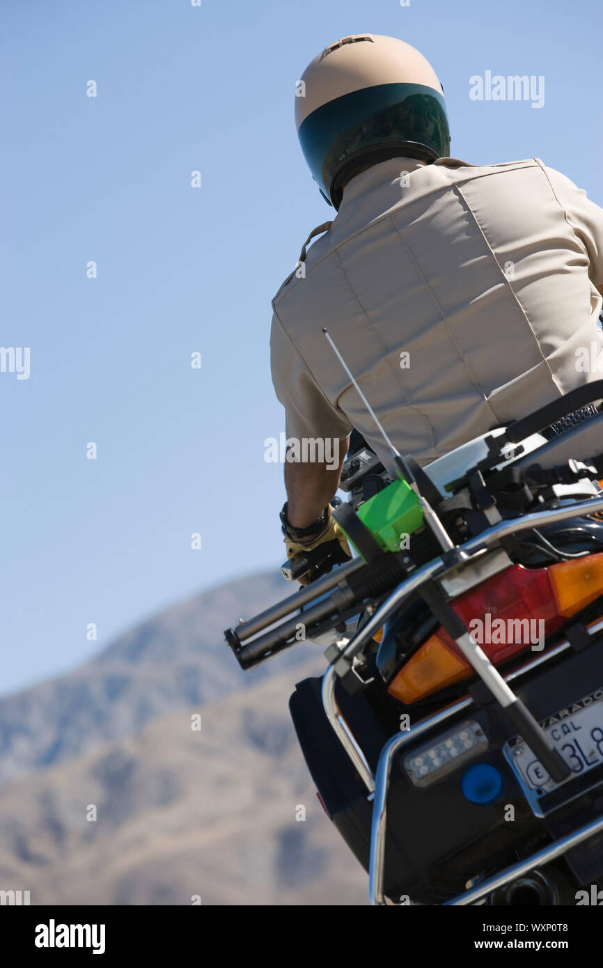 Back view of Police officer on bike Stock Photo - Alamy