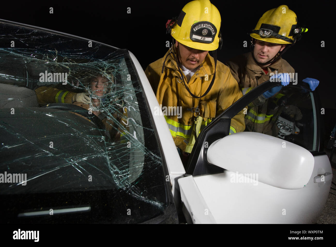 Firefighters rescuing car accident victim Stock Photo - Alamy