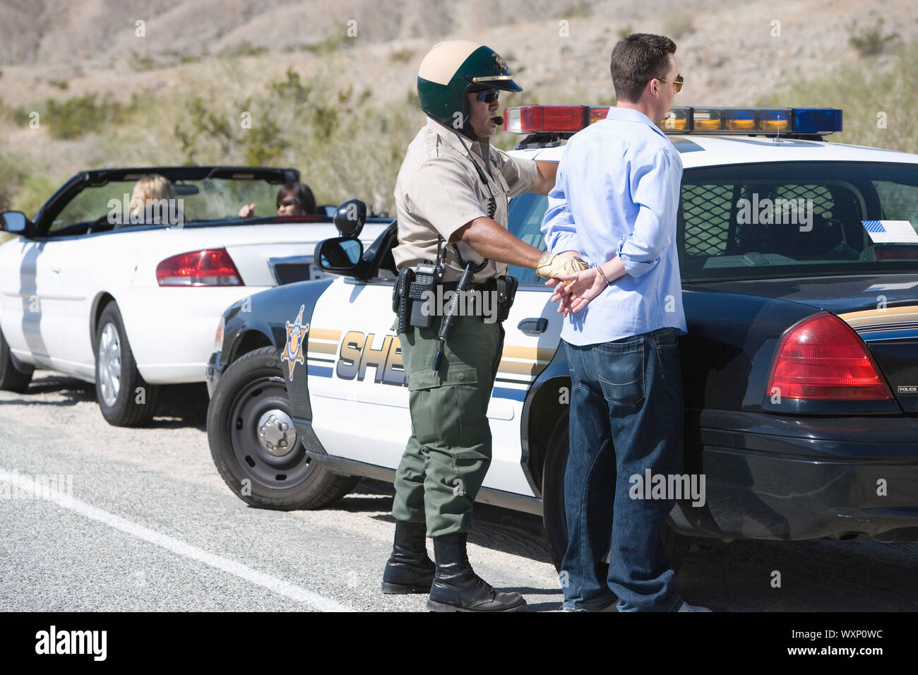 Police officer arresting driver Stock Photo - Alamy