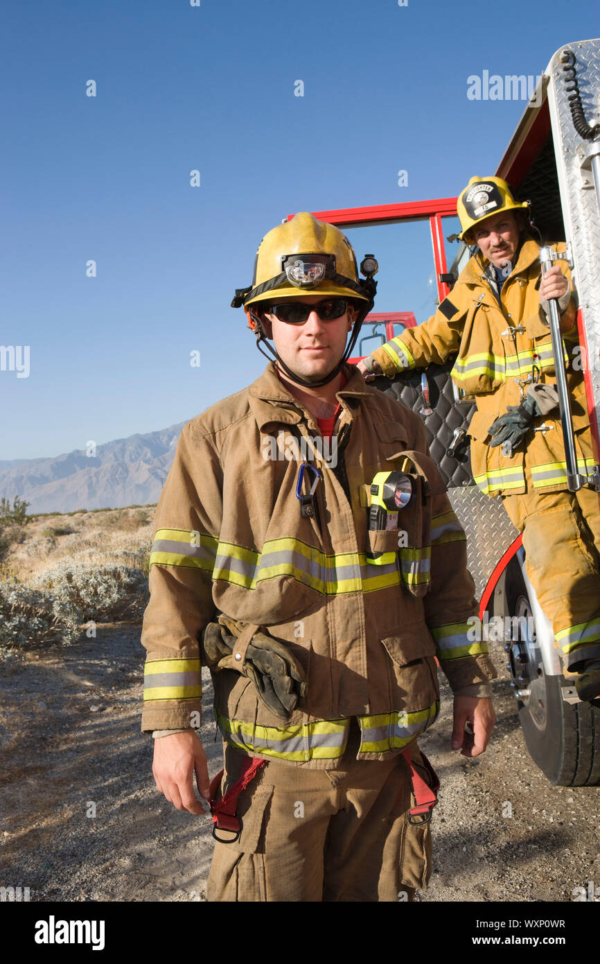 Firefighters and truck Stock Photo - Alamy