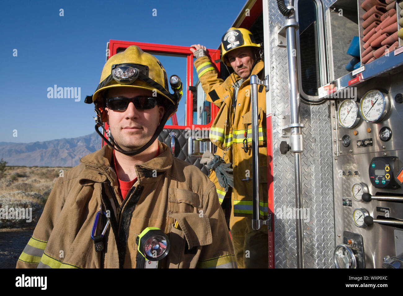 Firefighters and truck Stock Photo - Alamy