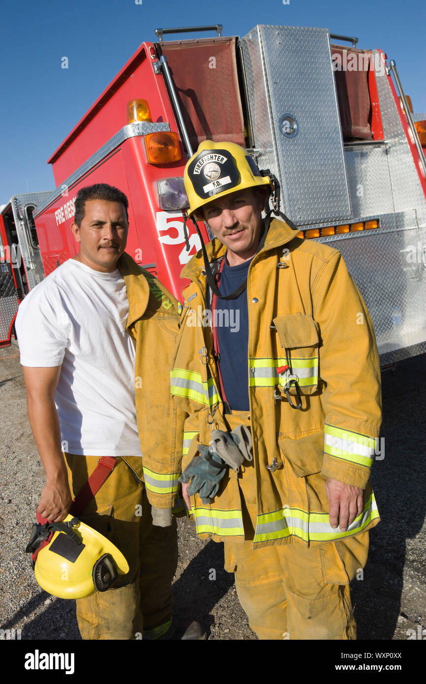 Firefighters in front of truck Stock Photo - Alamy