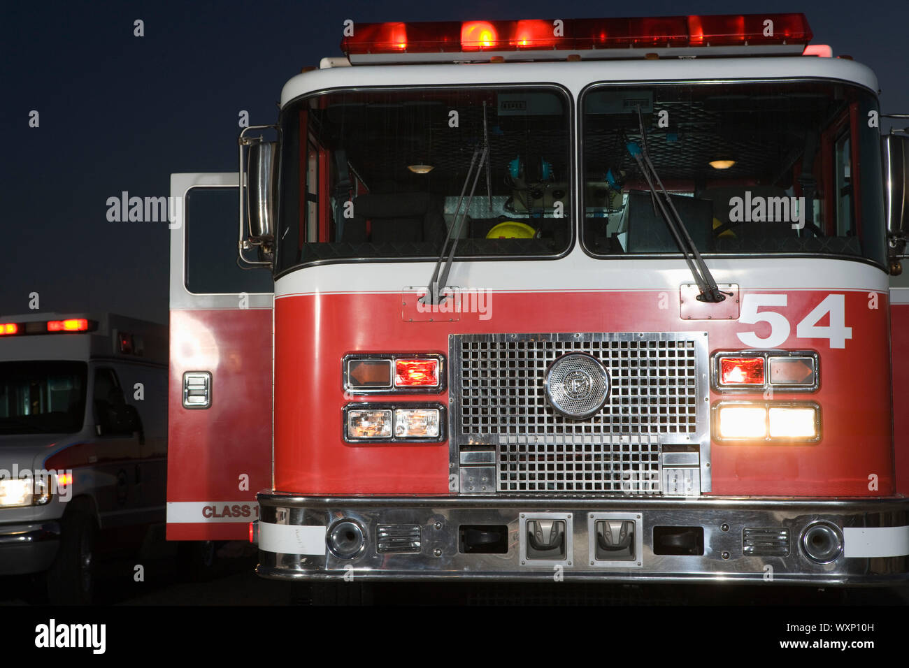 Fire engine and ambulance at night Stock Photo - Alamy