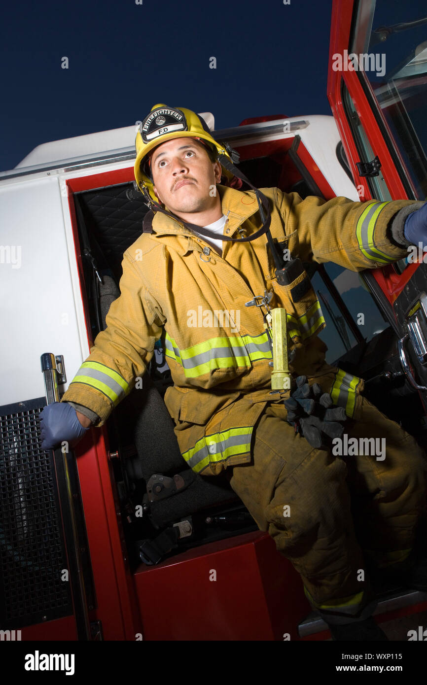 Firefighter exiting fire engine Stock Photo - Alamy