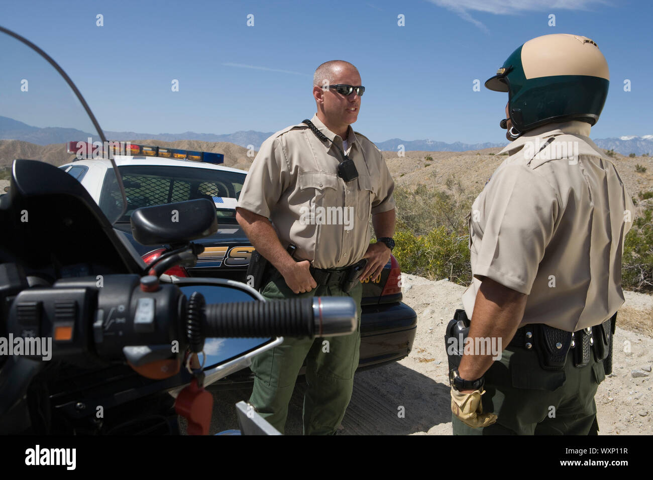 Police men talking on road Stock Photo - Alamy