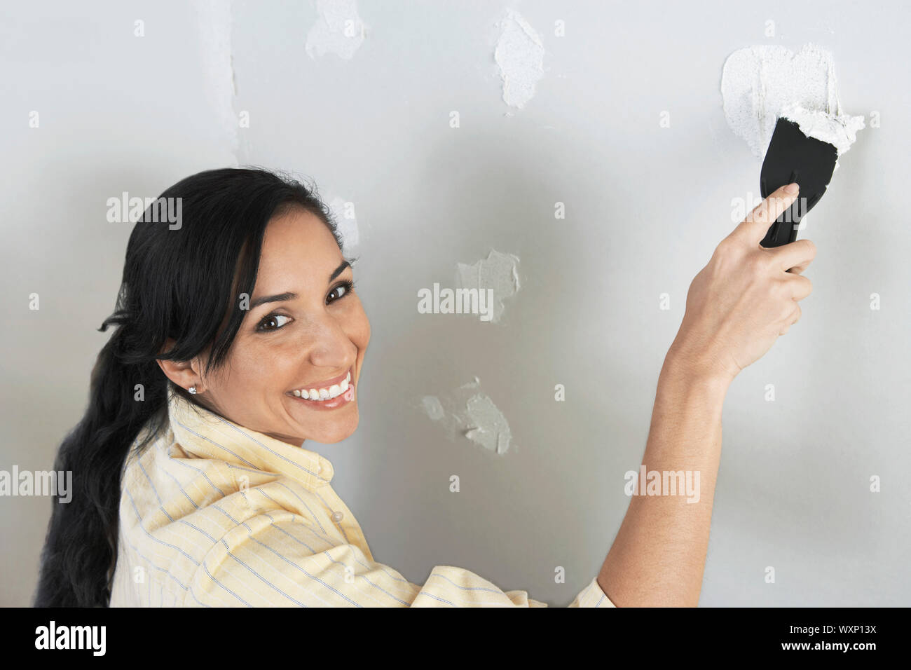 Woman Spackling Wall Stock Photo - Alamy