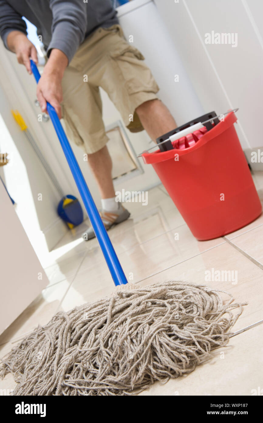 Man mopping floor Stock Photo - Alamy