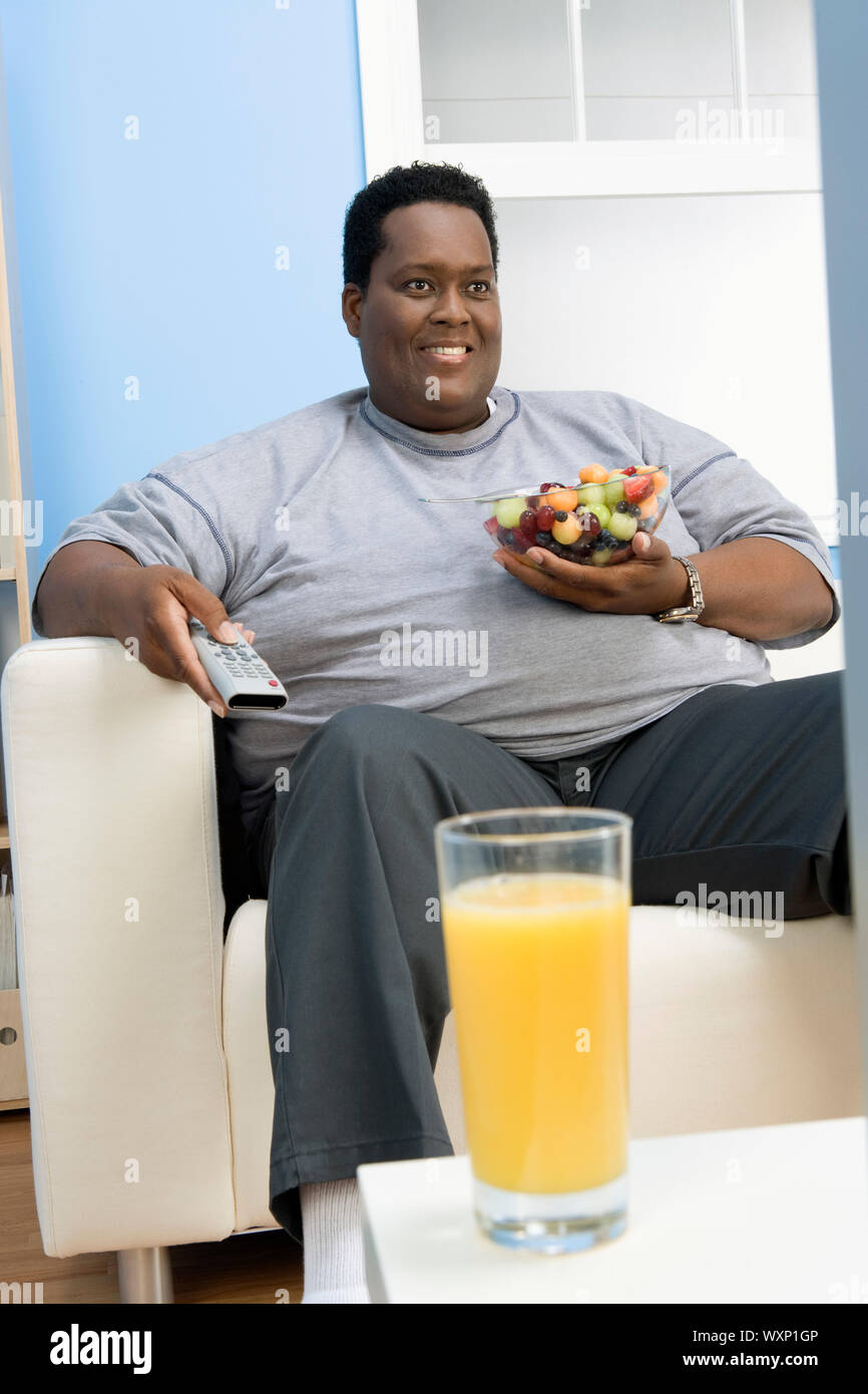 Man Eating Bowl of Fruit Stock Photo - Alamy