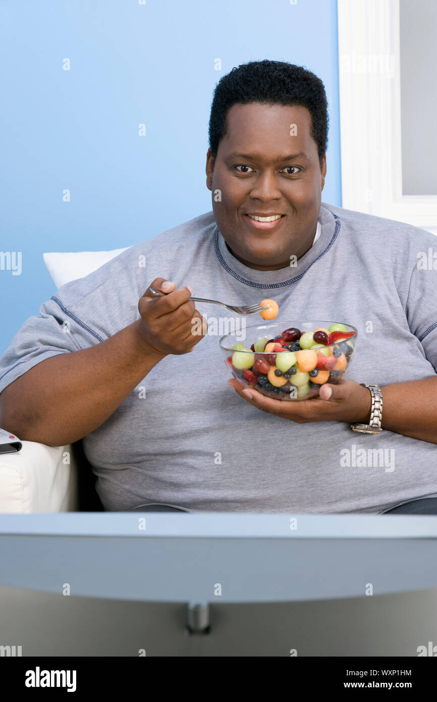 Man Eating Bowl of Fruit Stock Photo - Alamy