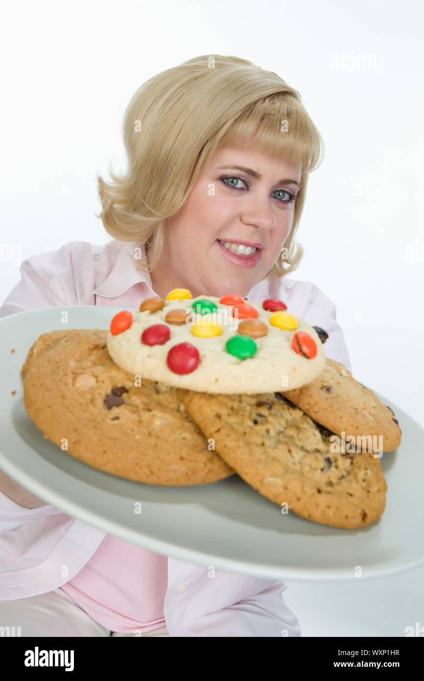 Woman Holding Plate of Cookies Stock Photo - Alamy