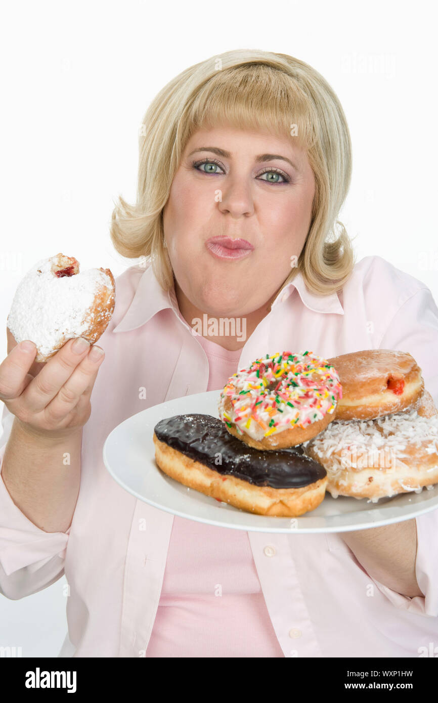 Woman Eating Donuts Stock Photo - Alamy