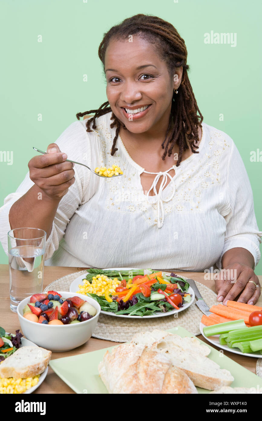 Overweight mid-adult woman having healthy meal Stock Photo - Alamy