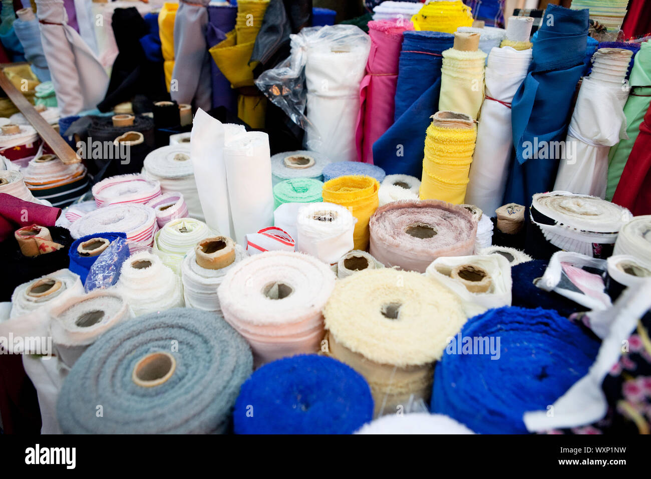 An abstract background of various rolls of cloth Stock Photo - Alamy
