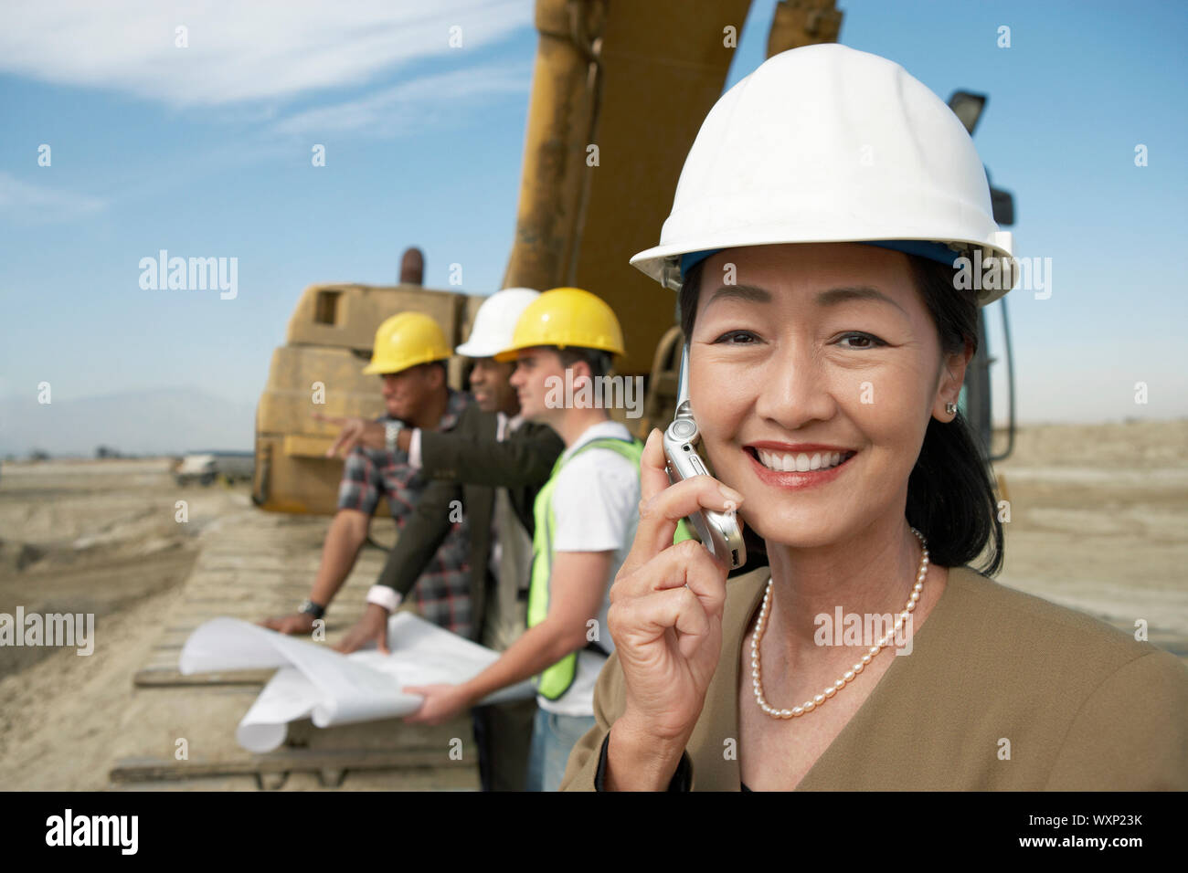 Surveyor Using Cell Phone on Construction Site Stock Photo - Alamy