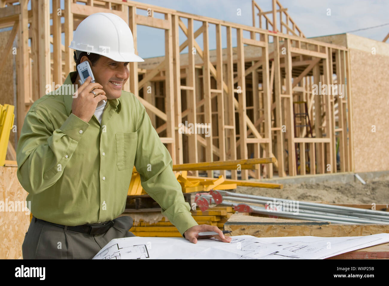 Construction worker using mobile phone Stock Photo - Alamy