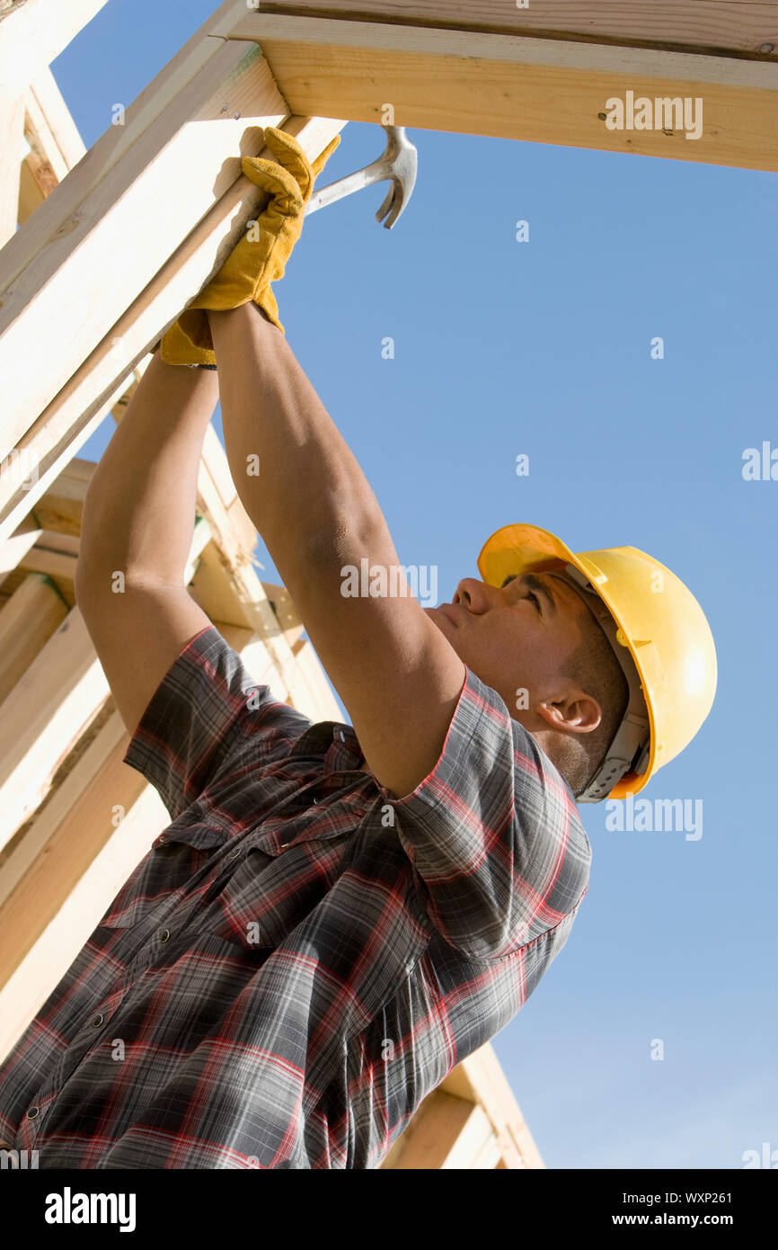 Construction worker checking building Stock Photo - Alamy