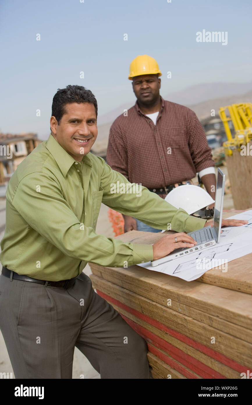 Construction worker using laptop, portrait Stock Photo - Alamy