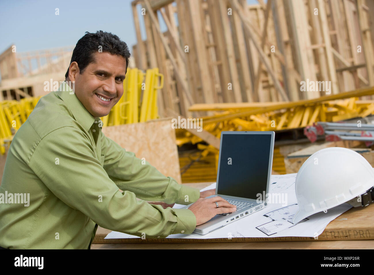 Construction worker using laptop, portrait Stock Photo - Alamy