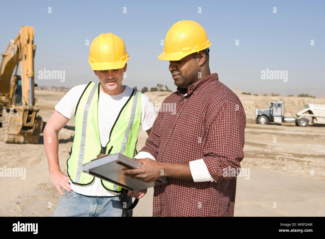 Two construction workers on site Stock Photo - Alamy
