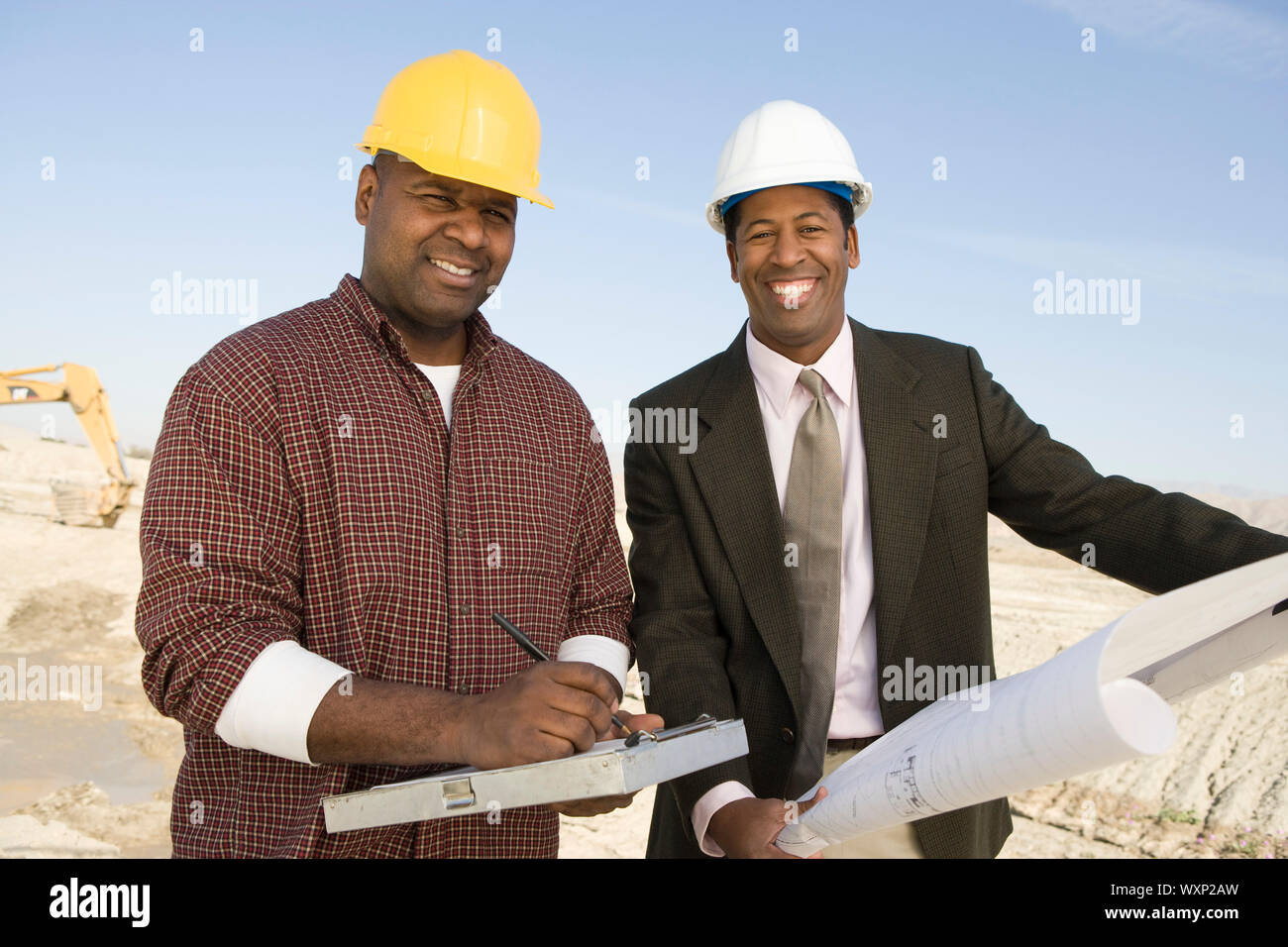 Surveyor and construction worker with blueprints, portrait Stock Photo ...