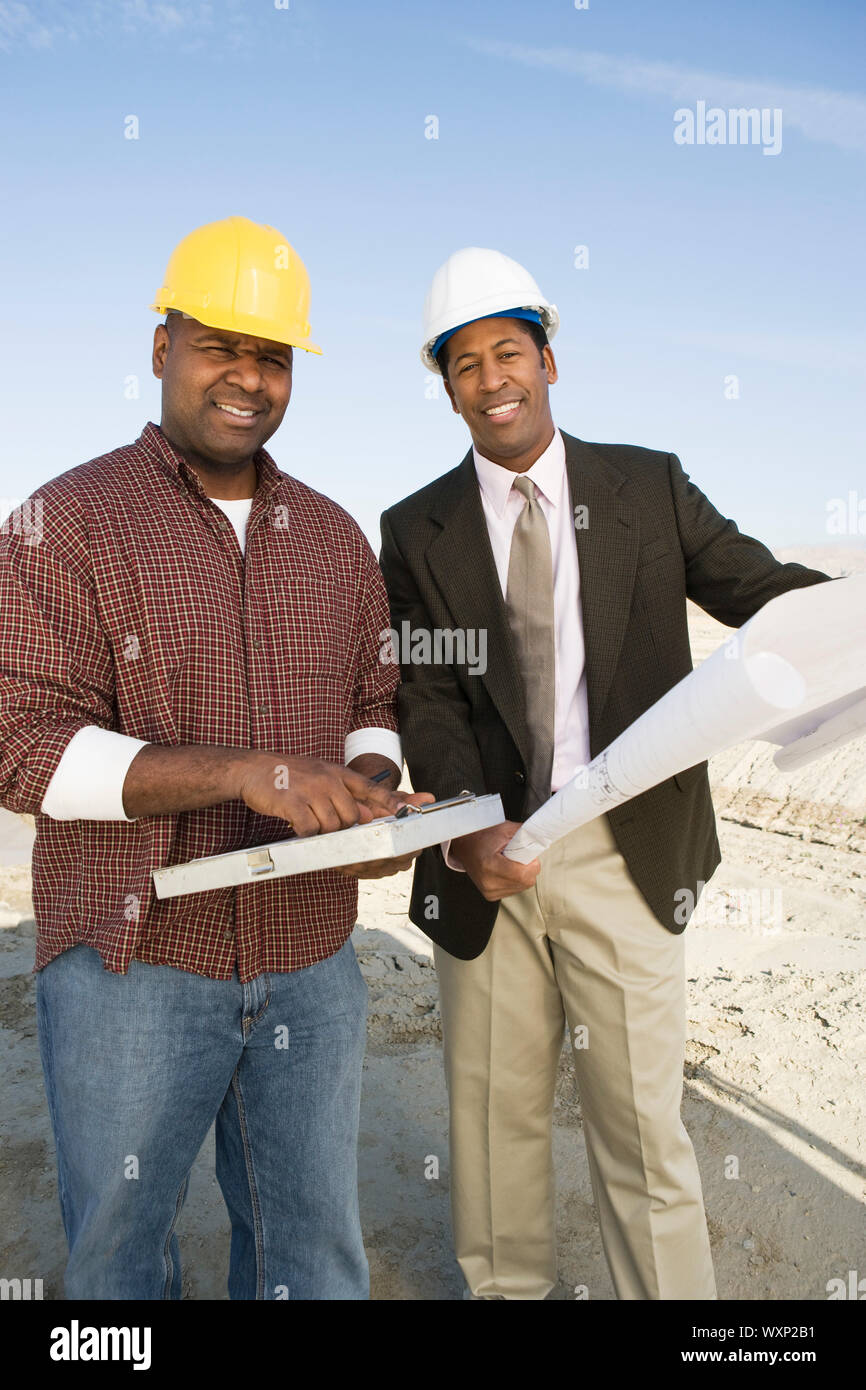 Surveyor and construction worker with blueprints, portrait Stock Photo ...