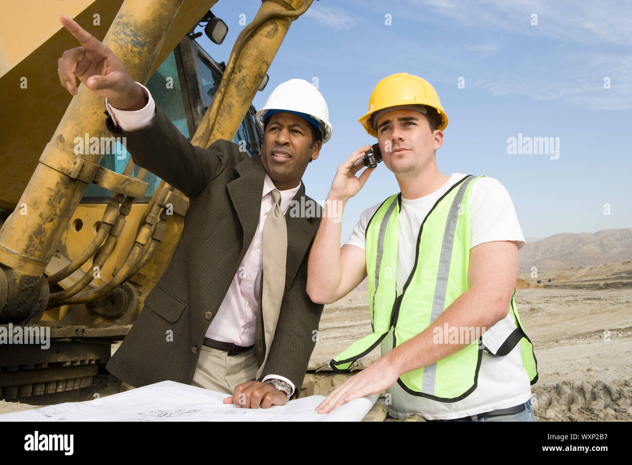 Surveyor and construction worker with blueprints Stock Photo - Alamy