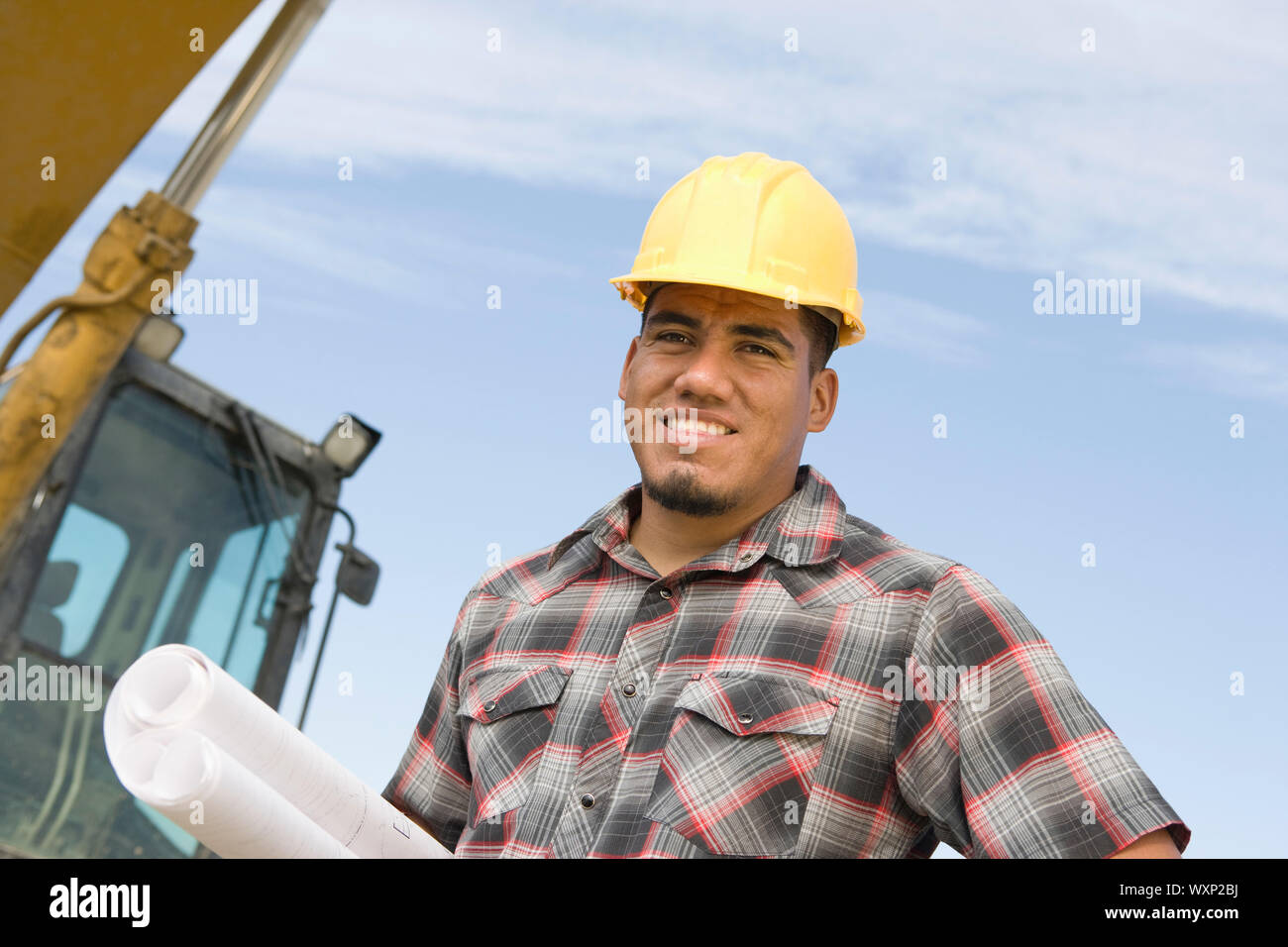 Construction worker holding blueprints, portrait Stock Photo - Alamy