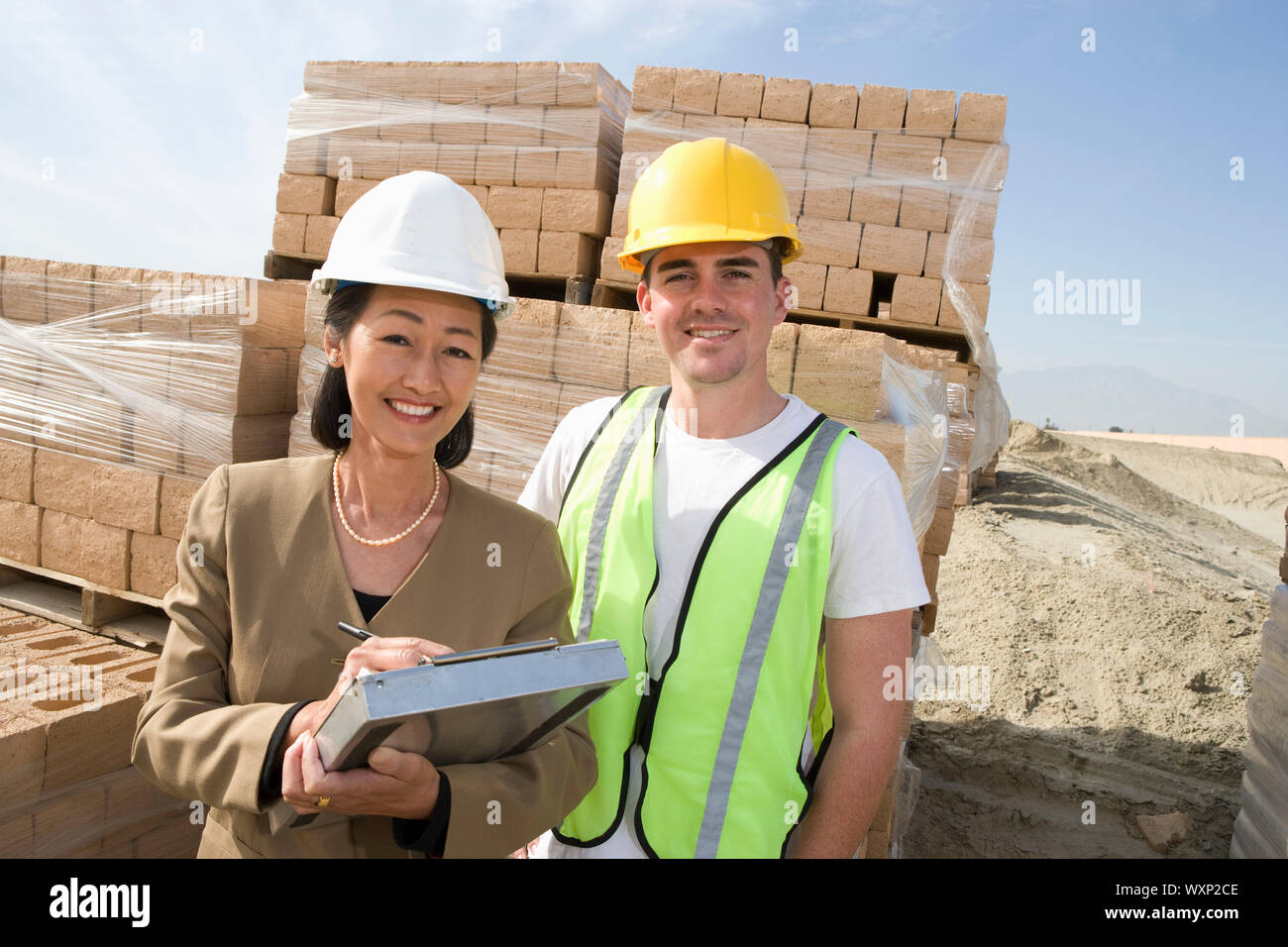 Architect and construction worker standing on construction site Stock ...