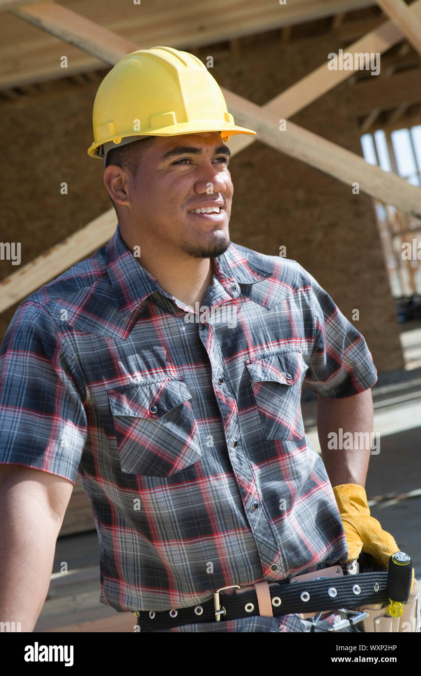 Construction worker standing on construction site Stock Photo - Alamy