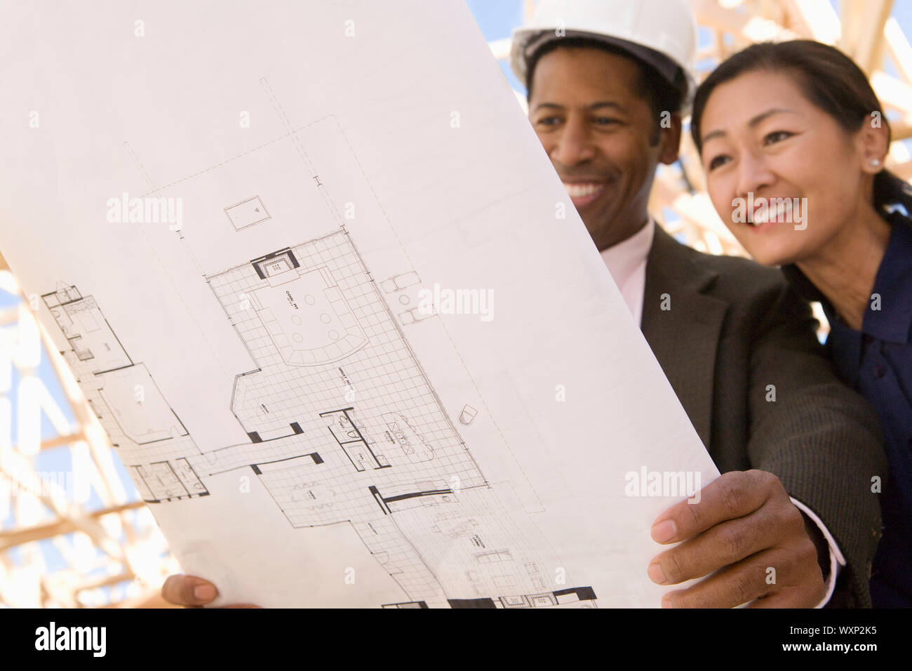 Architect looking at blueprints Stock Photo - Alamy