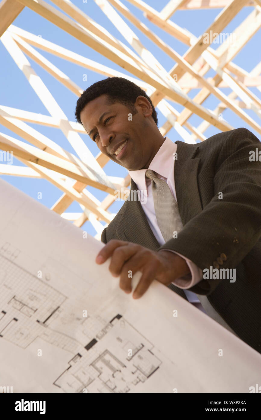Architect looking at blueprints Stock Photo - Alamy