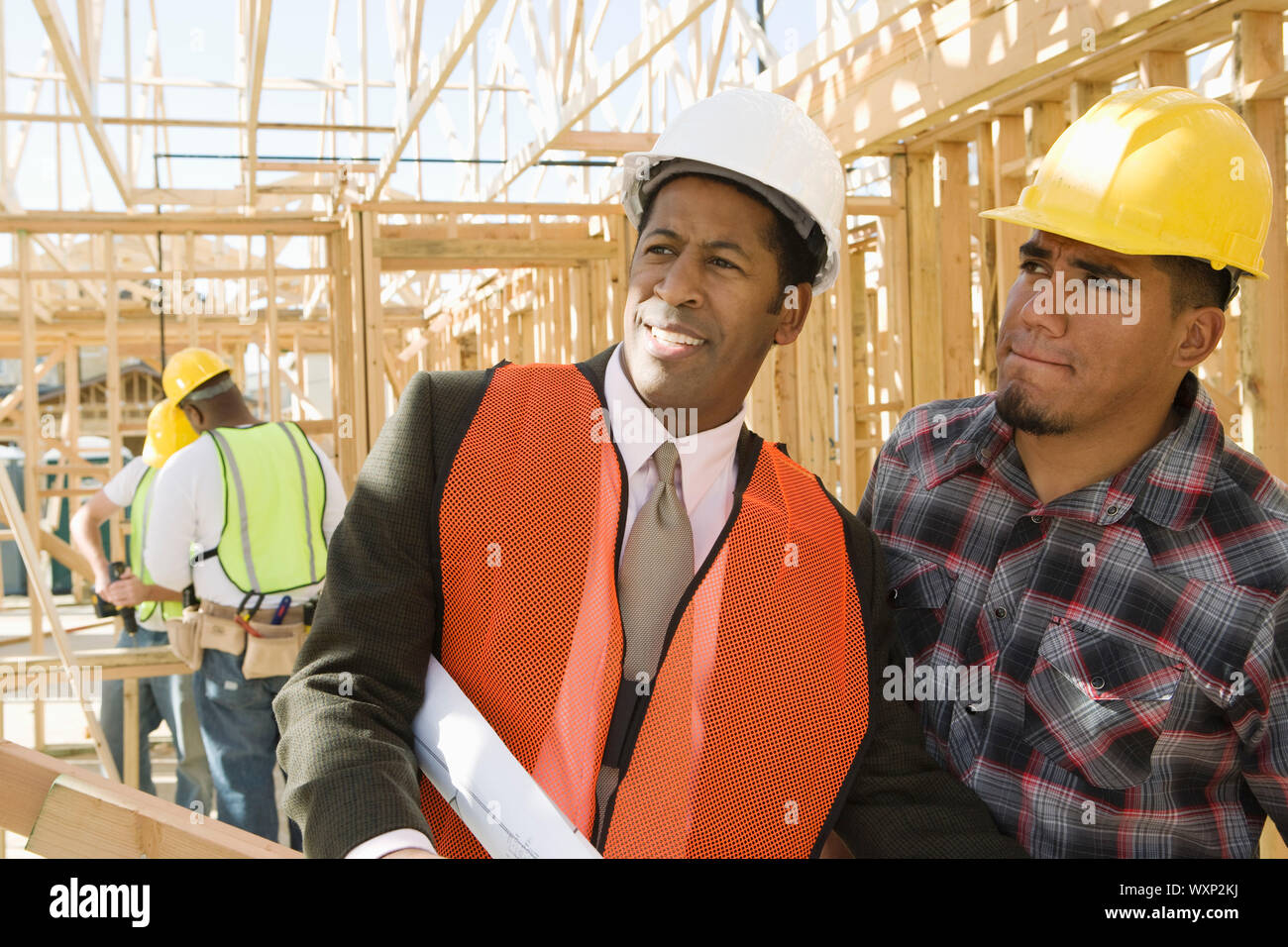 Architect and construction worker standing on construction site Stock ...