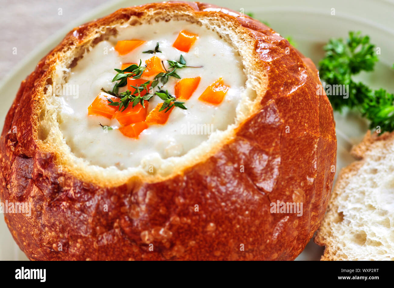 Lunch of soup served in baked round bread bowl Stock Photo - Alamy