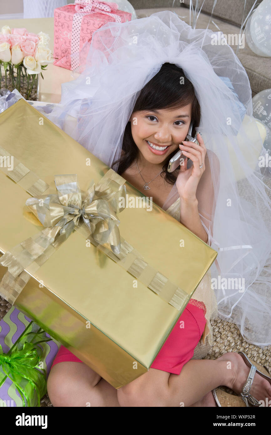Bride using mobile phone at bridal shower Stock Photo - Alamy