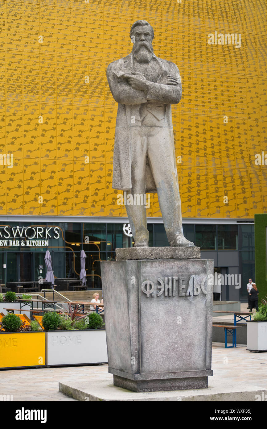 Statue of Friedrich Engels infront of a yellow facade in Tony Wilson ...