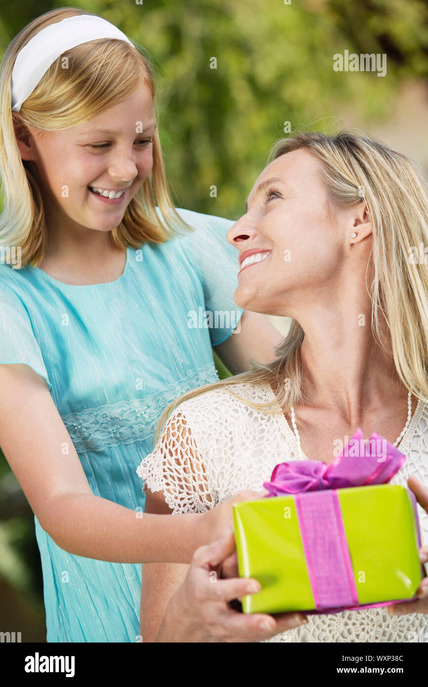 Girl Giving Mother Gift Stock Photo - Alamy