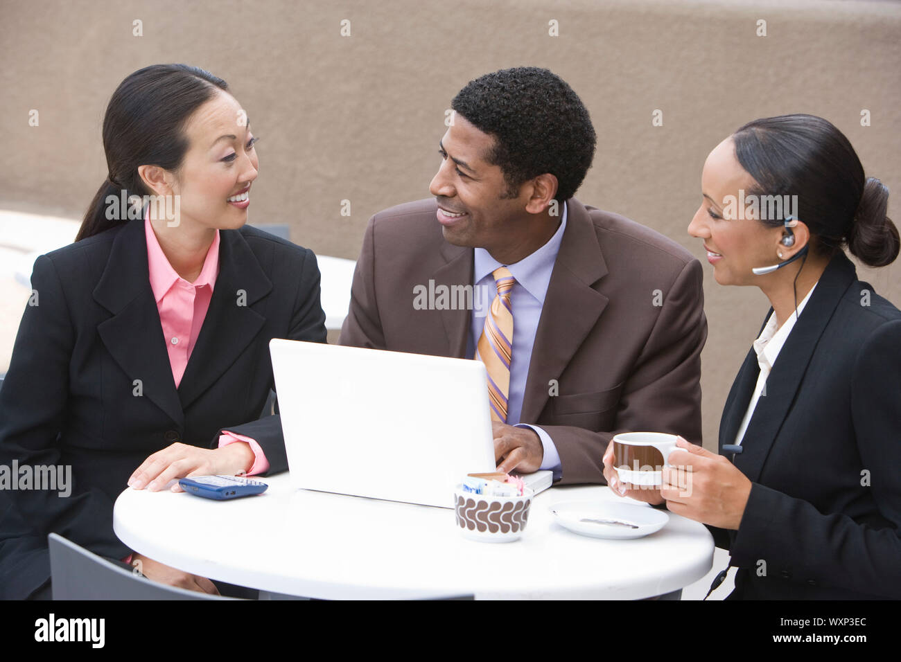 Three business people having meeting Stock Photo - Alamy