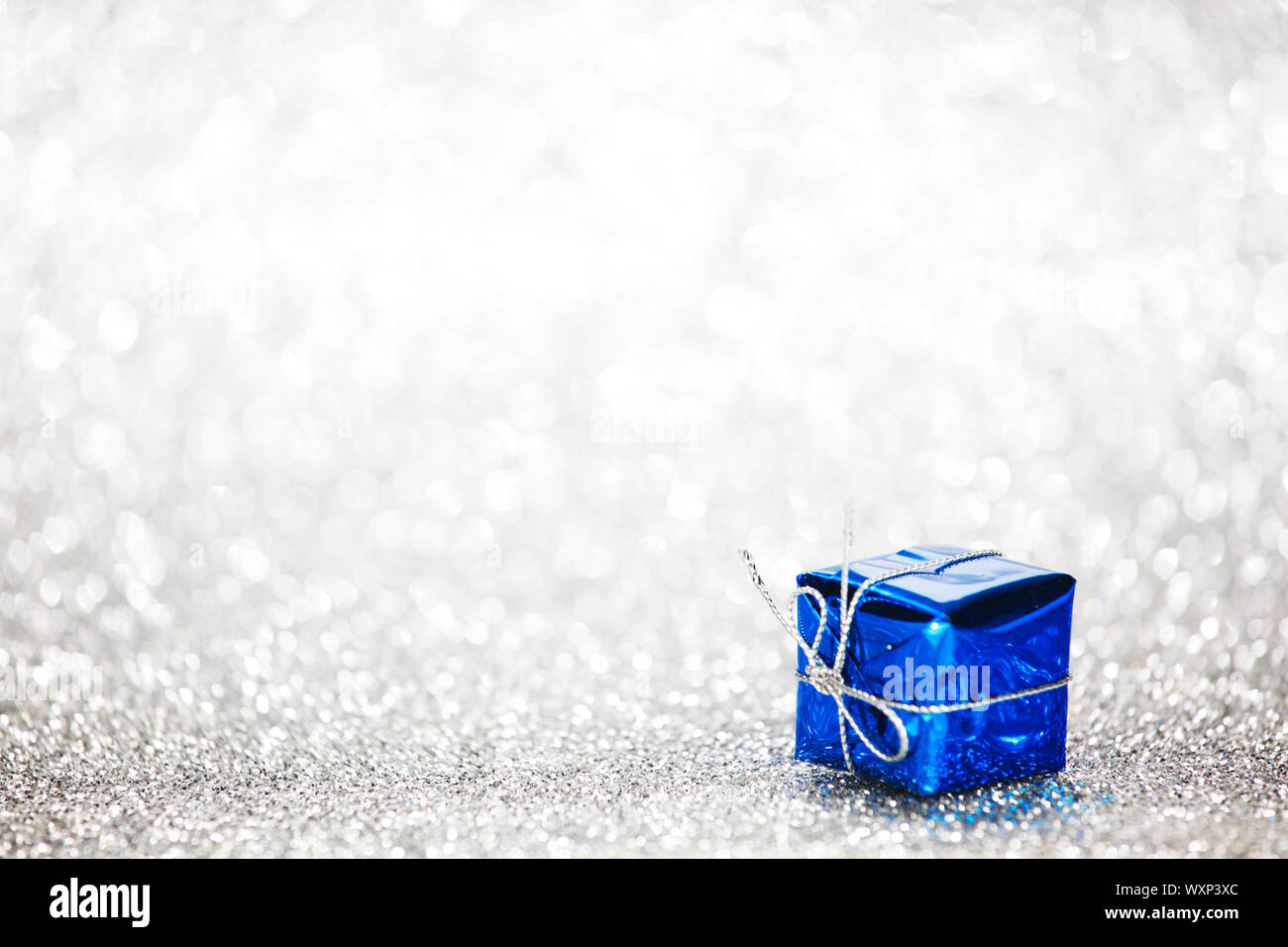 Gift box on glitter silver background Stock Photo - Alamy