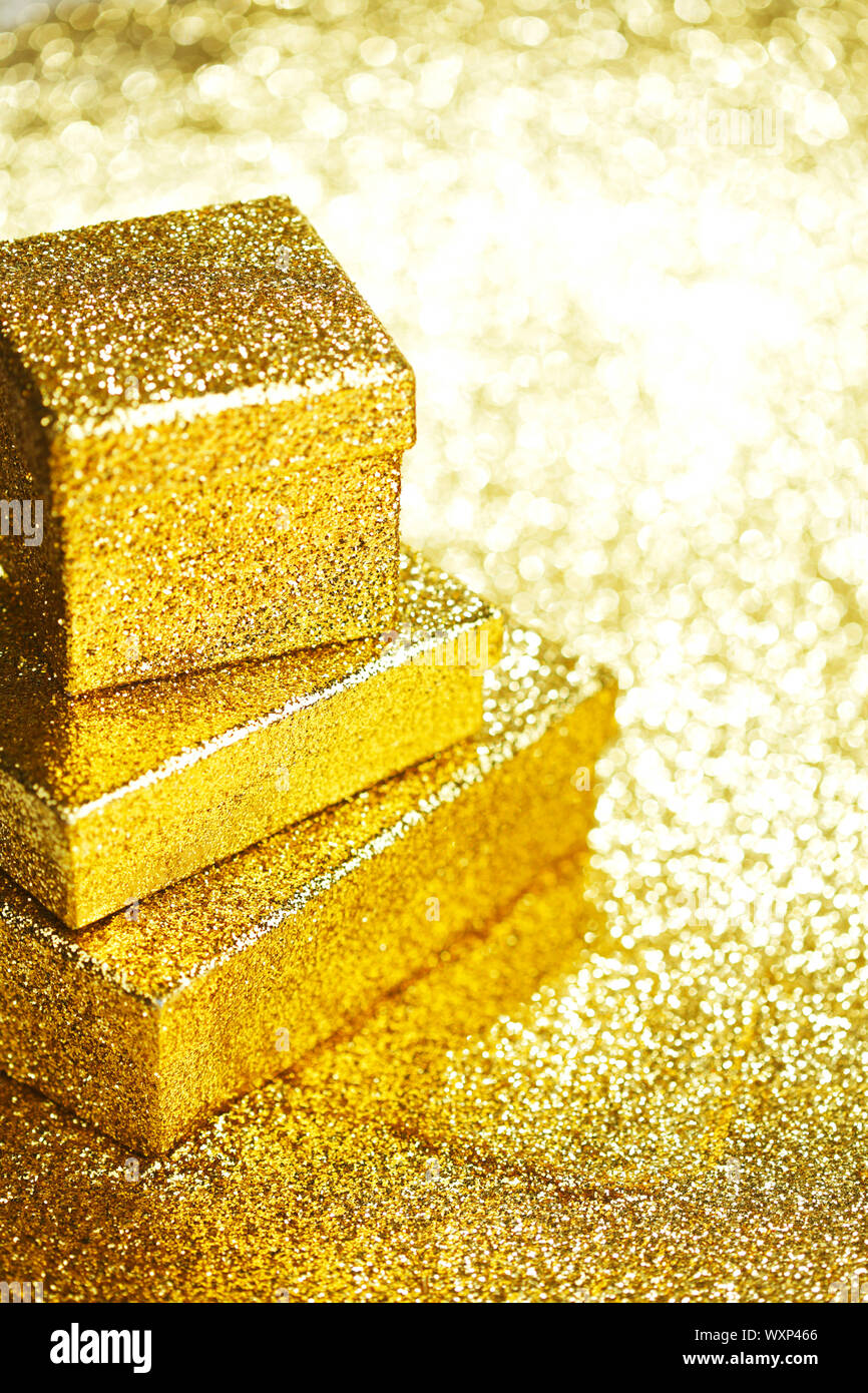 Golden boxes with holiday gifts on shiny glitter background Stock Photo ...