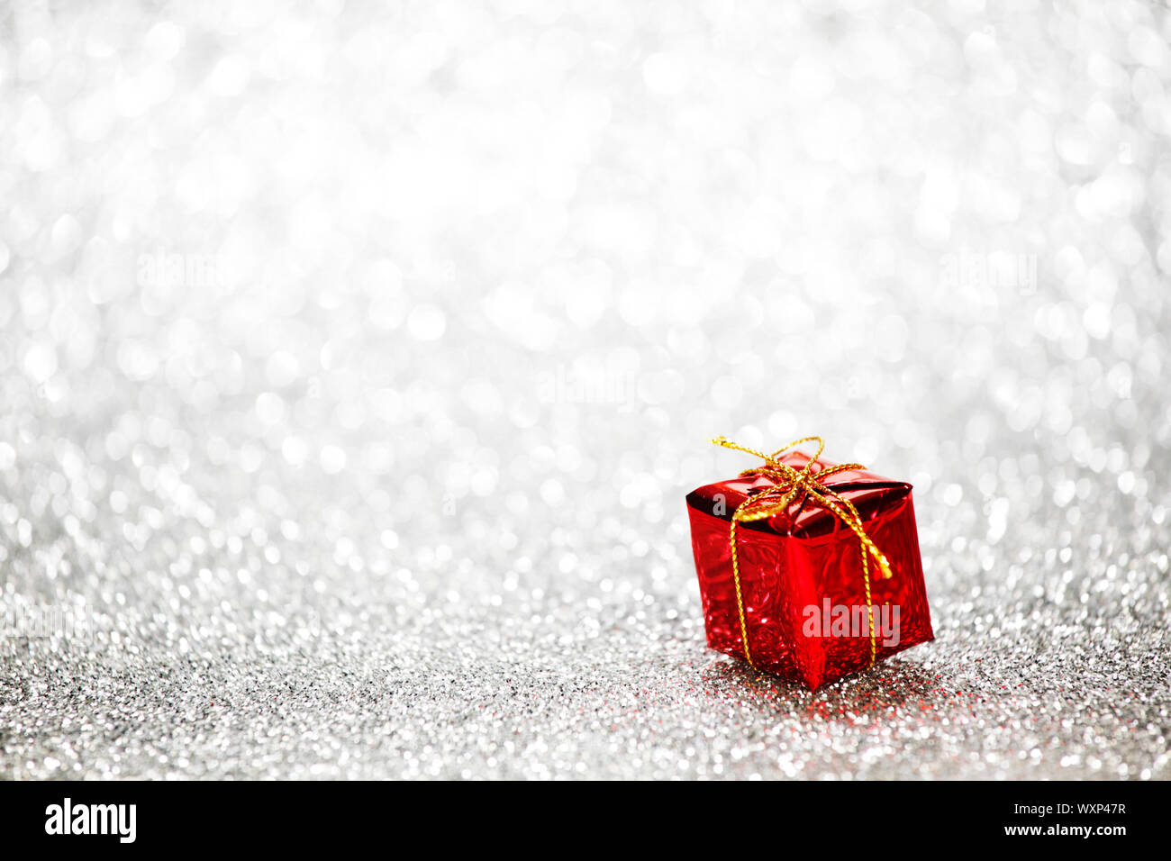 Gift box on glitter silver background Stock Photo - Alamy