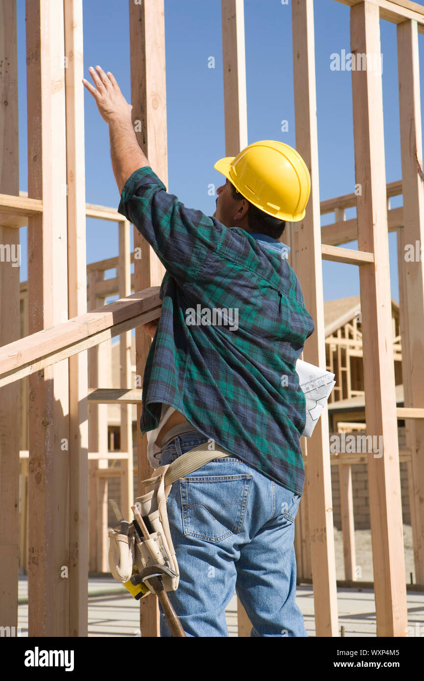 Construction Worker standing in front of house construction and ...