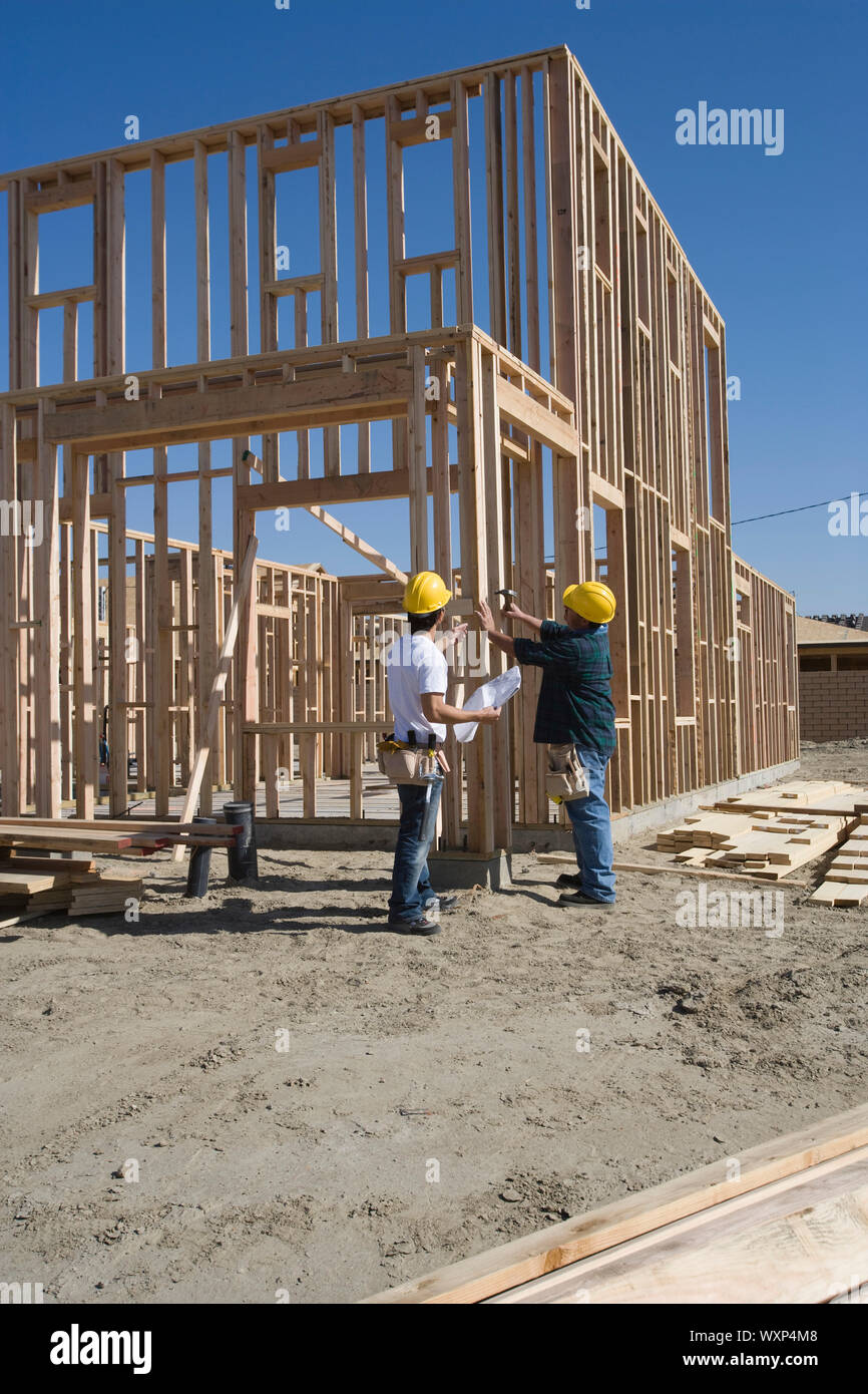 Construction workers on building site Stock Photo - Alamy