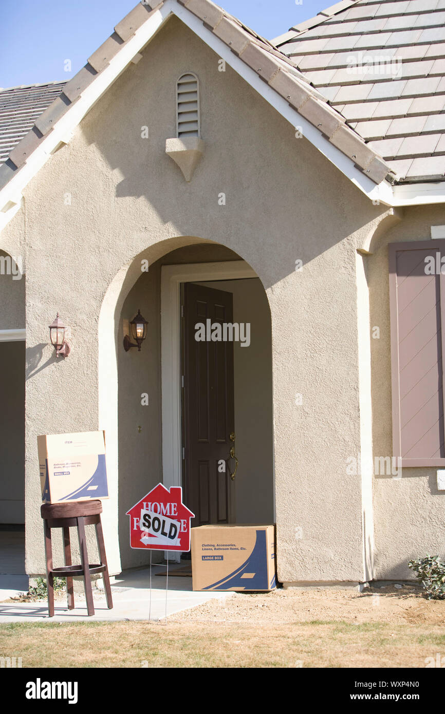 Facade of house with sold sign and few cardboard boxes Stock Photo - Alamy