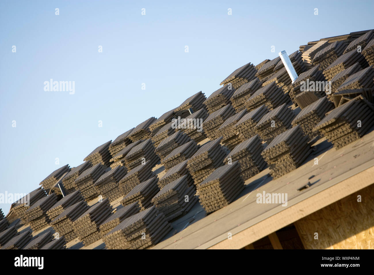 Close-up view of stacks of roof tiles on roof, construction site Stock ...