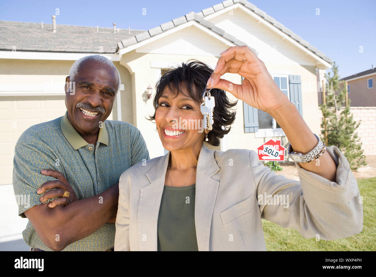 Portrait of middle-aged couple with keys to new house Stock Photo - Alamy